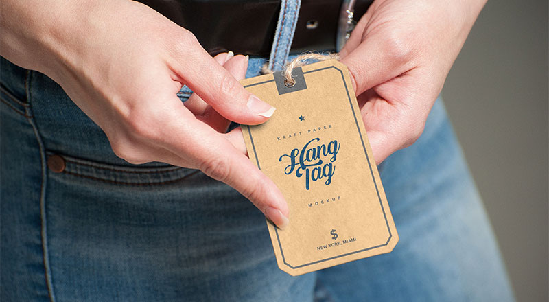 Free Hand Holding Kraft Paper Hang Tag Mockup PSD - Designbolts