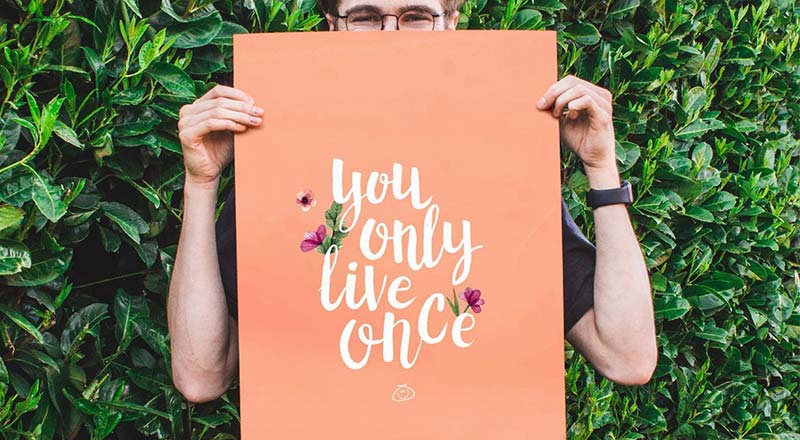 Free Hand Holding Poster Mockup PSD - Designbolts